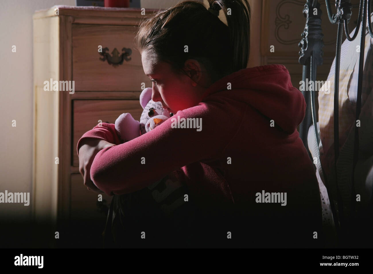 Teenage girl alone in bedroom Stock Photo - Alamy