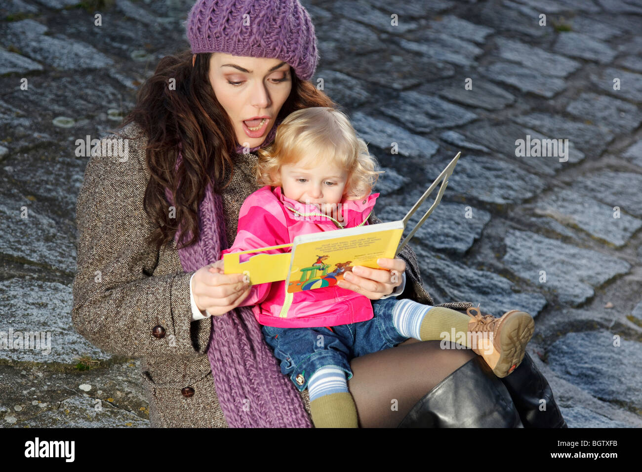 woman reading book with little girl Stock Photo - Alamy