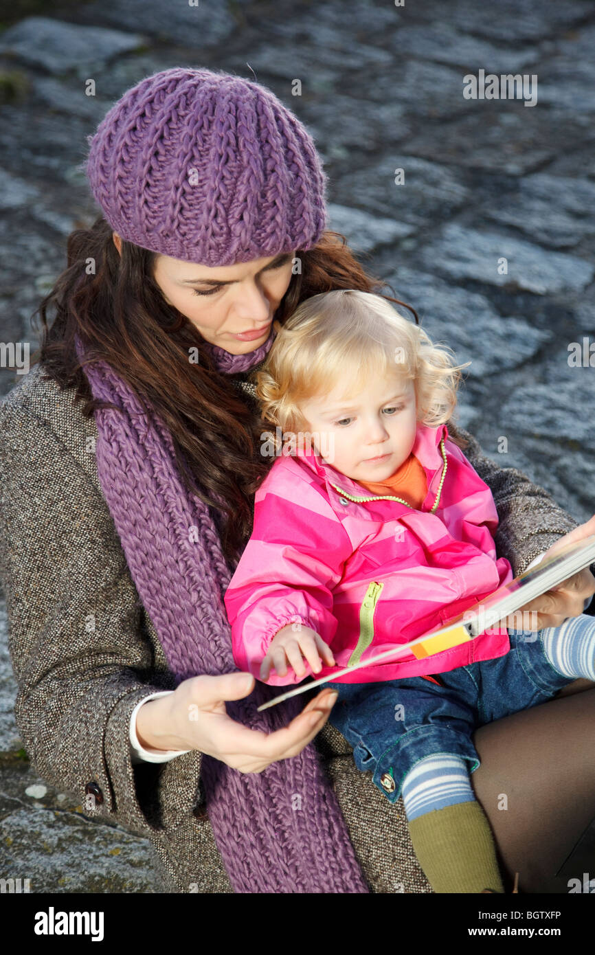 woman reading book with little girl Stock Photo - Alamy