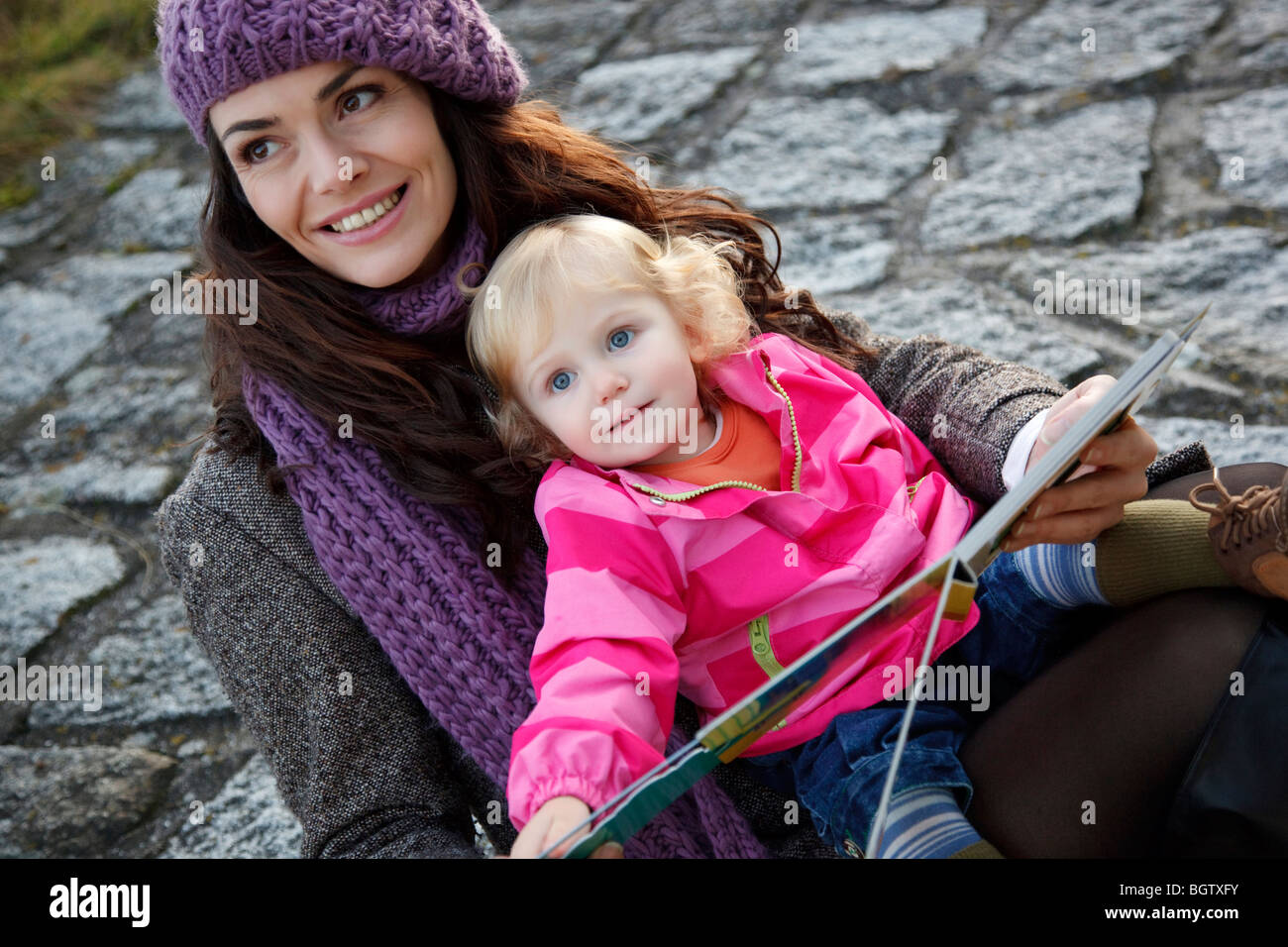 woman reading book with little girl Stock Photo - Alamy