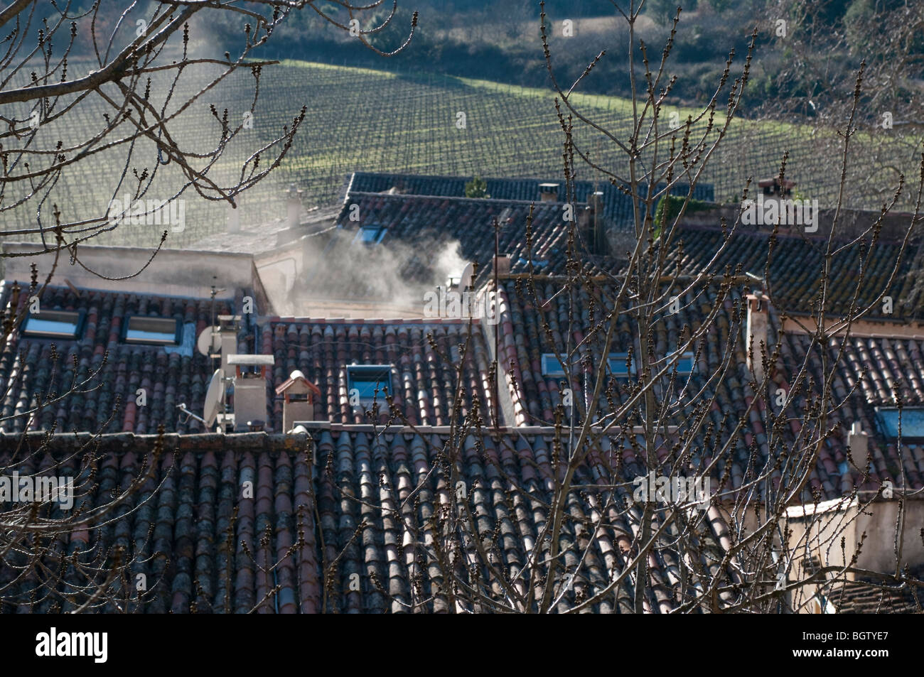 Rooftops and smoking chimney in the medieval village of St Jean de ...