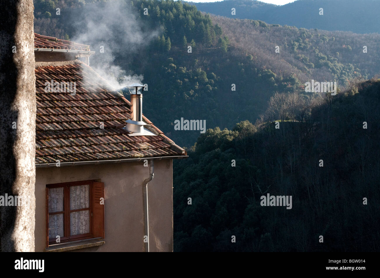 Smoke coming from chimney in a house in St Martial, medieval village in ...