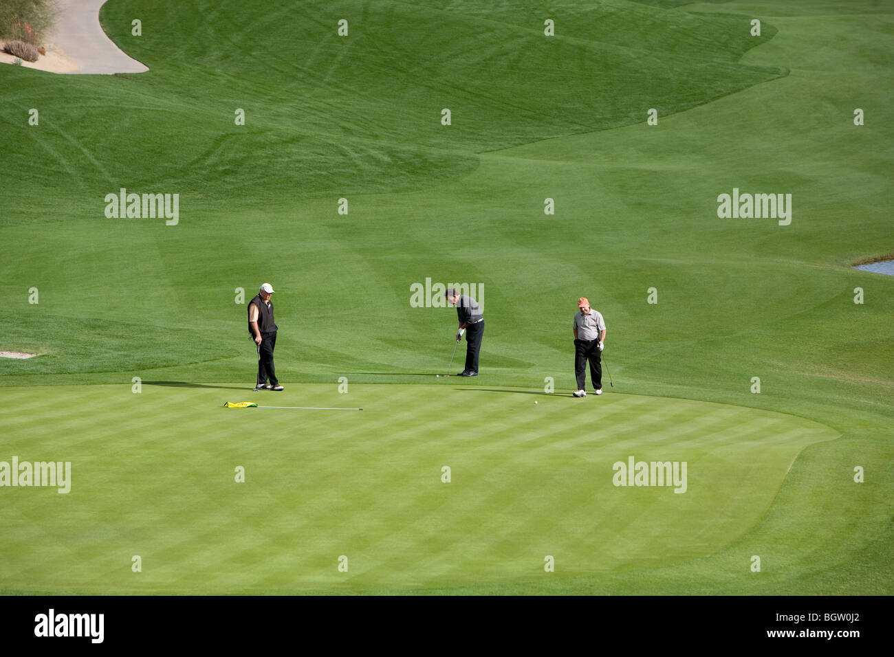 Golfers play on a municipal golf course near Palm Springs, California ...