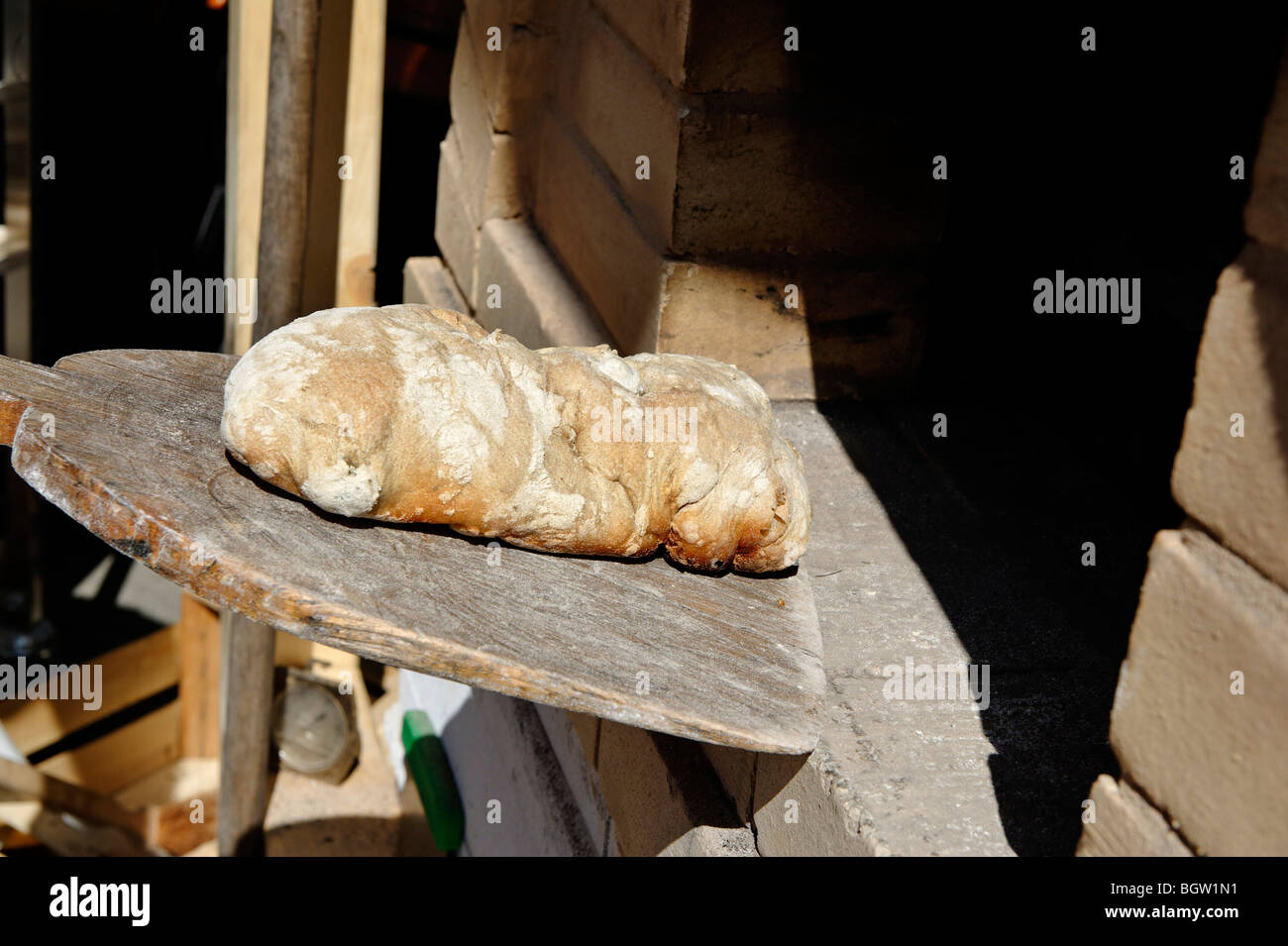 Fresh-baked loaf of bread in front of baking oven Stock Photo - Alamy