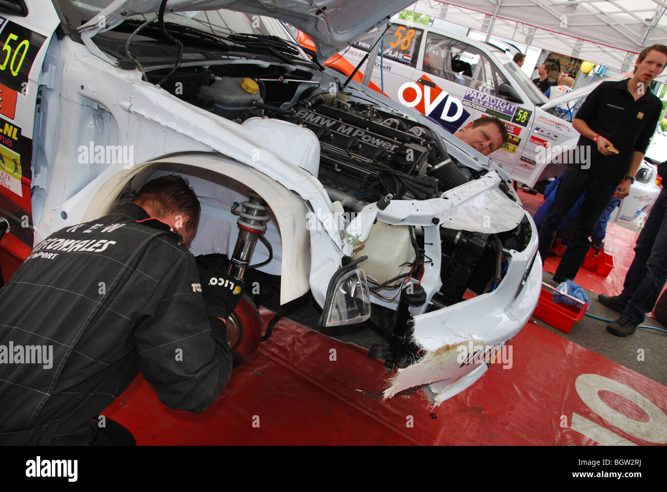 assessing accident damage on BMW rally car at at 2009 Dutch Paradigit ...