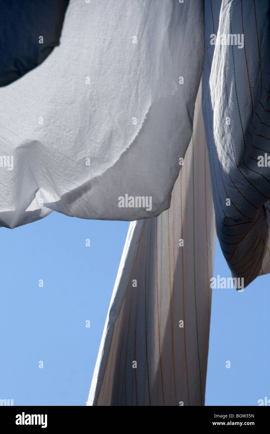 one white bed sheet hanging on washing line in sun Stock Photo - Alamy