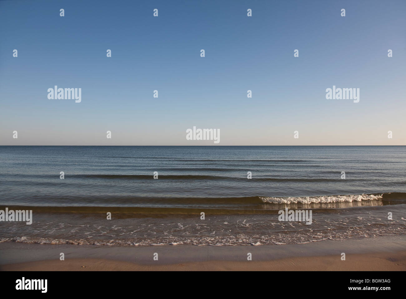 Gentle surf lapping against a golden shore Stock Photo - Alamy