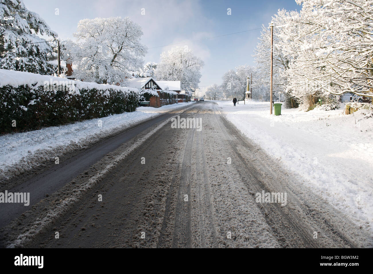 Snow roads with blue sky and lone walker, Mortimer, Berkshire Stock ...