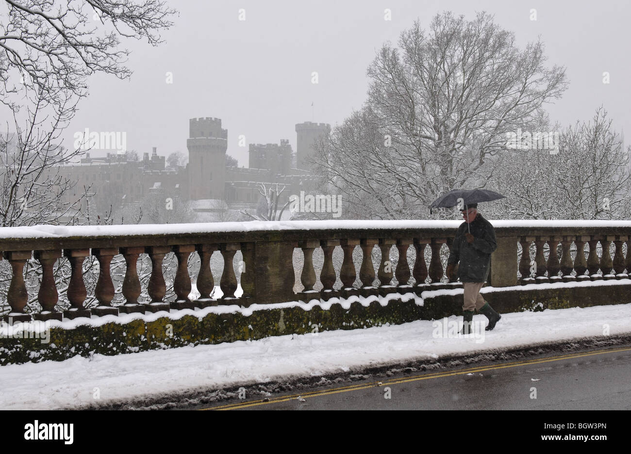 Warwick Castle from Banbury Road bridge during snowfall, Warwickshire ...