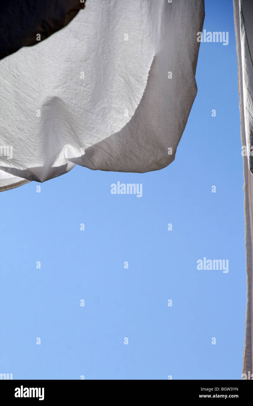 one white bed sheet hanging on washing line in sun Stock Photo - Alamy