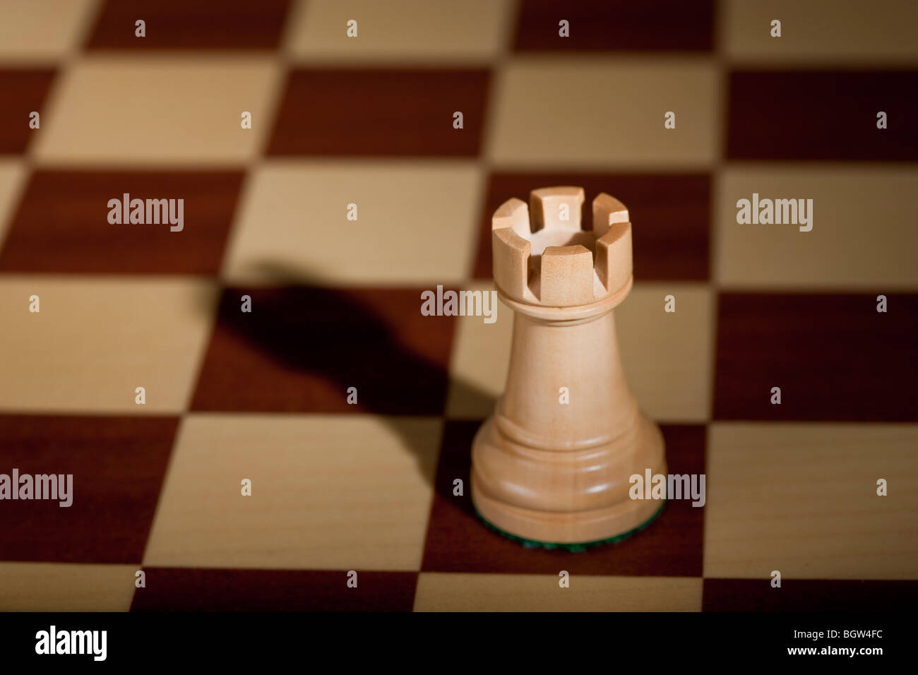 Chess piece - a white rook on a chessboard Stock Photo - Alamy