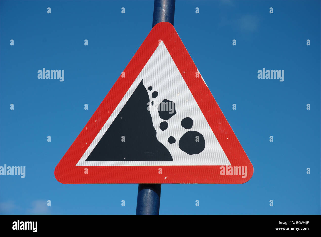Falling rocks warning sign on a post Stock Photo - Alamy