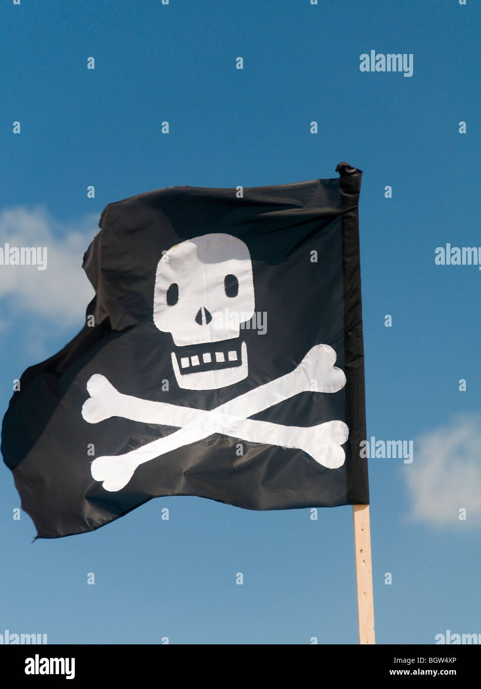 Pirate flag flying in the wind Stock Photo - Alamy