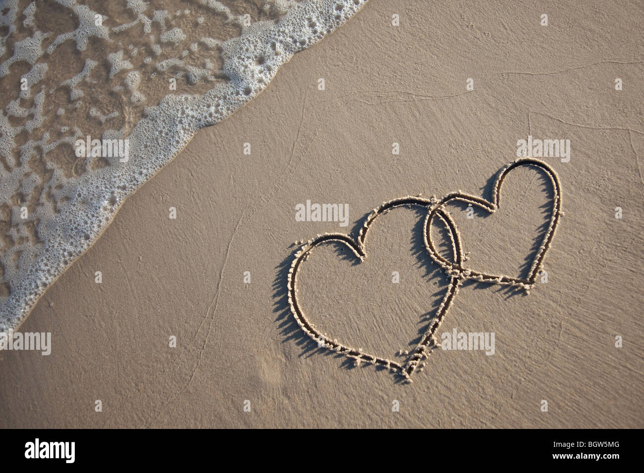 Two hearts at the beach Stock Photo - Alamy