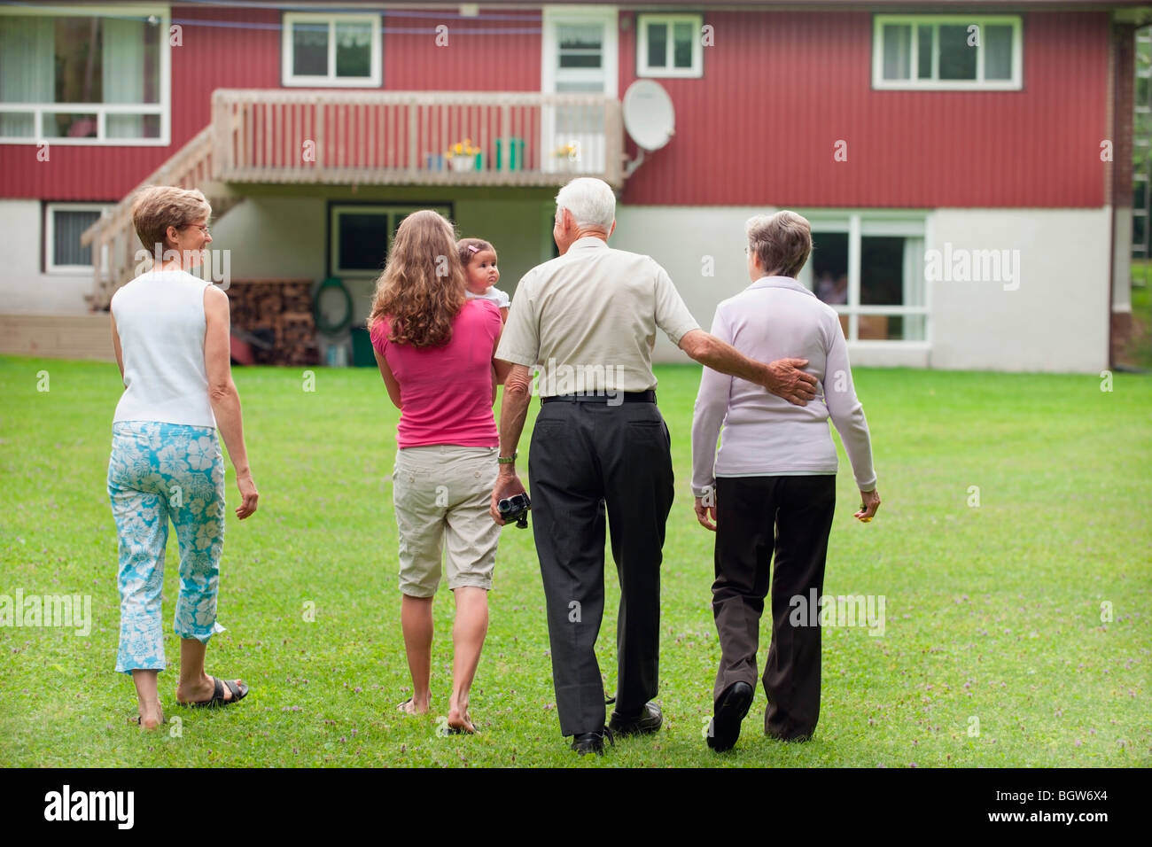 Four generations of family walking Stock Photo - Alamy