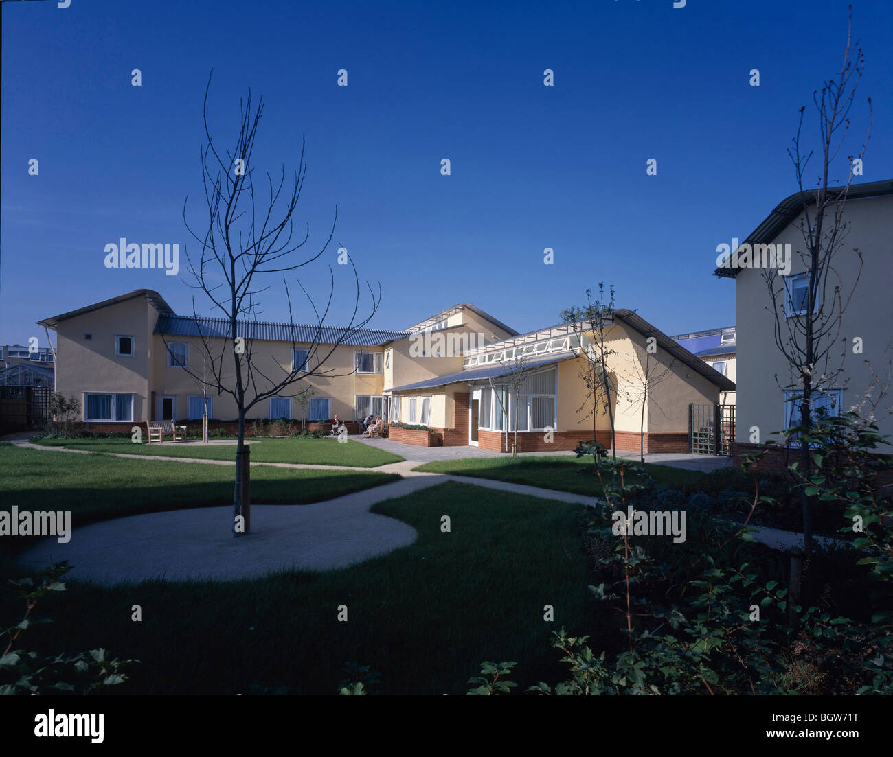 woodland nursing home exterior with blue sky and tree Stock Photo - Alamy