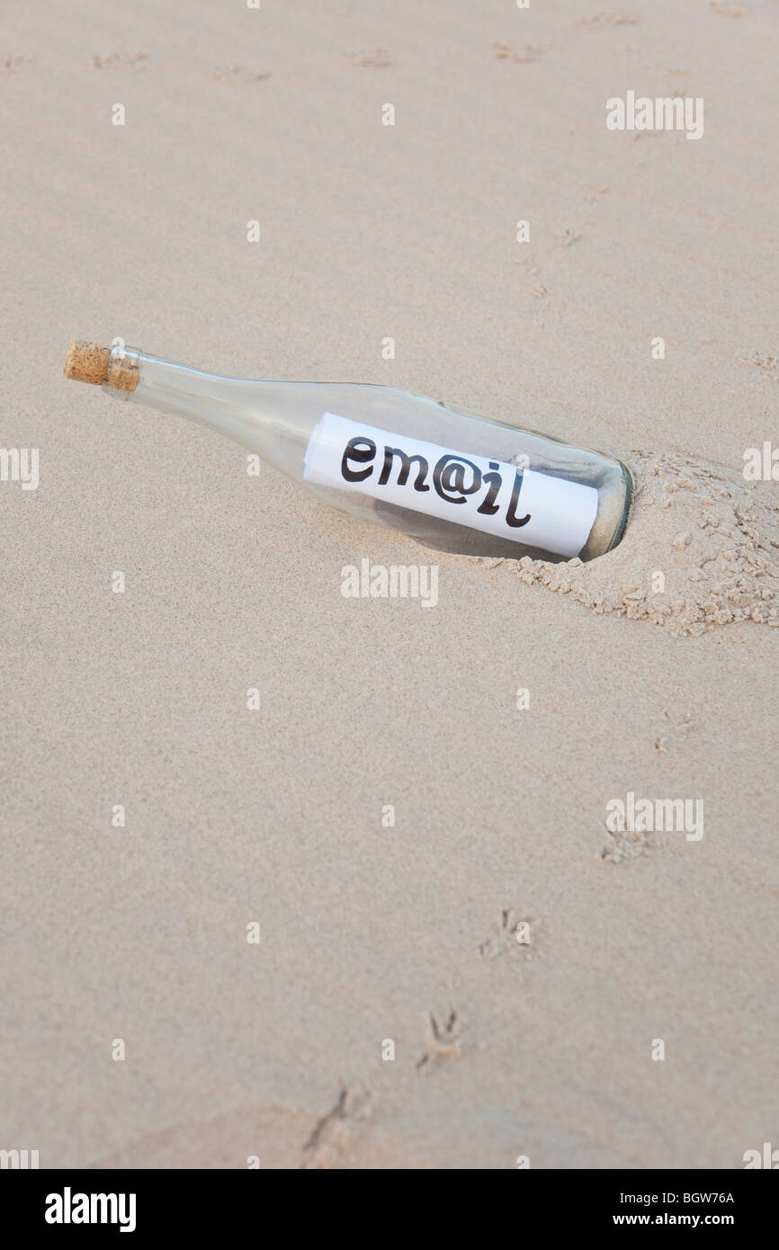 A clear glass bottle washed up on the beach Stock Photo - Alamy