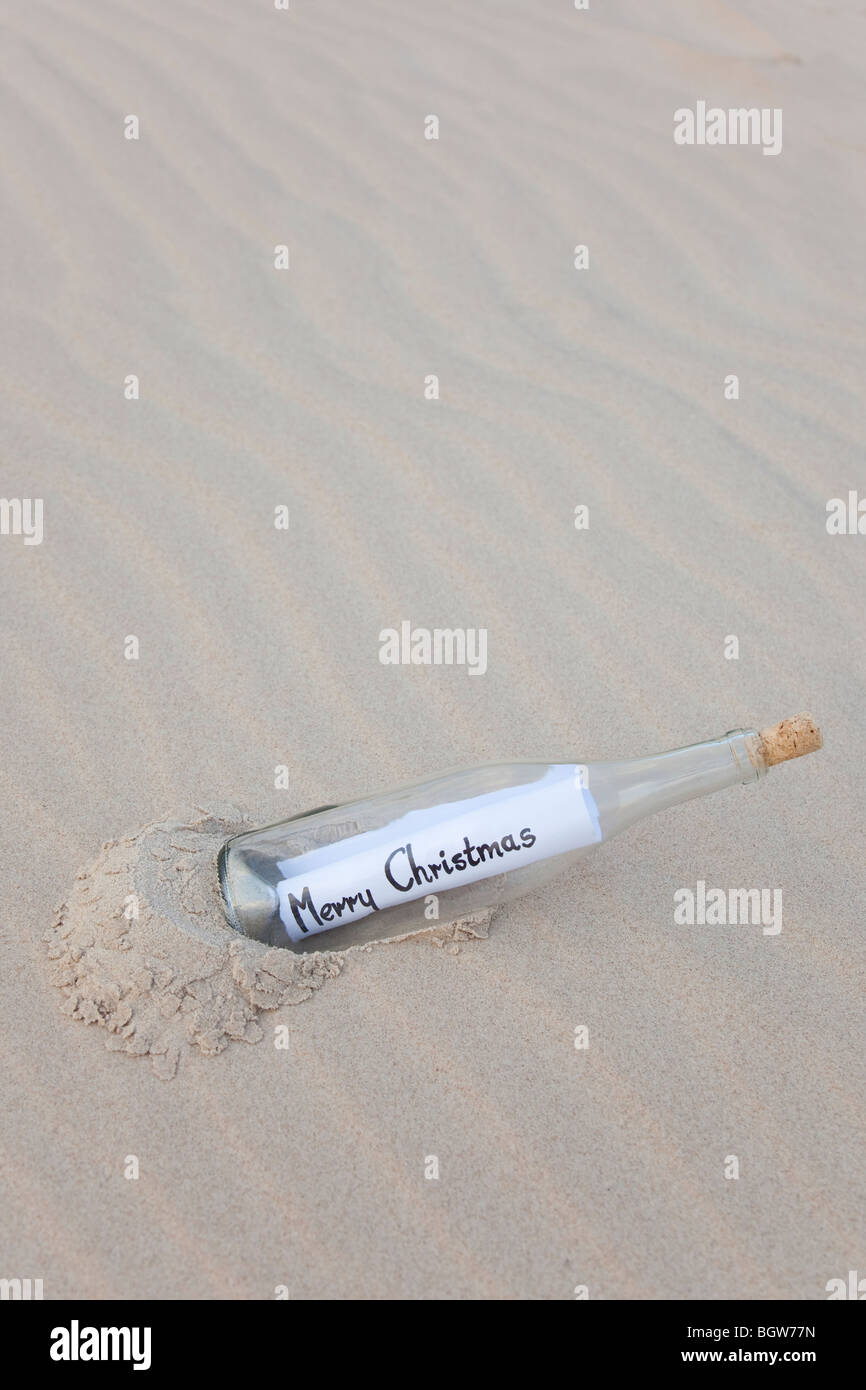 A clear glass bottle washed up on the beach Stock Photo - Alamy