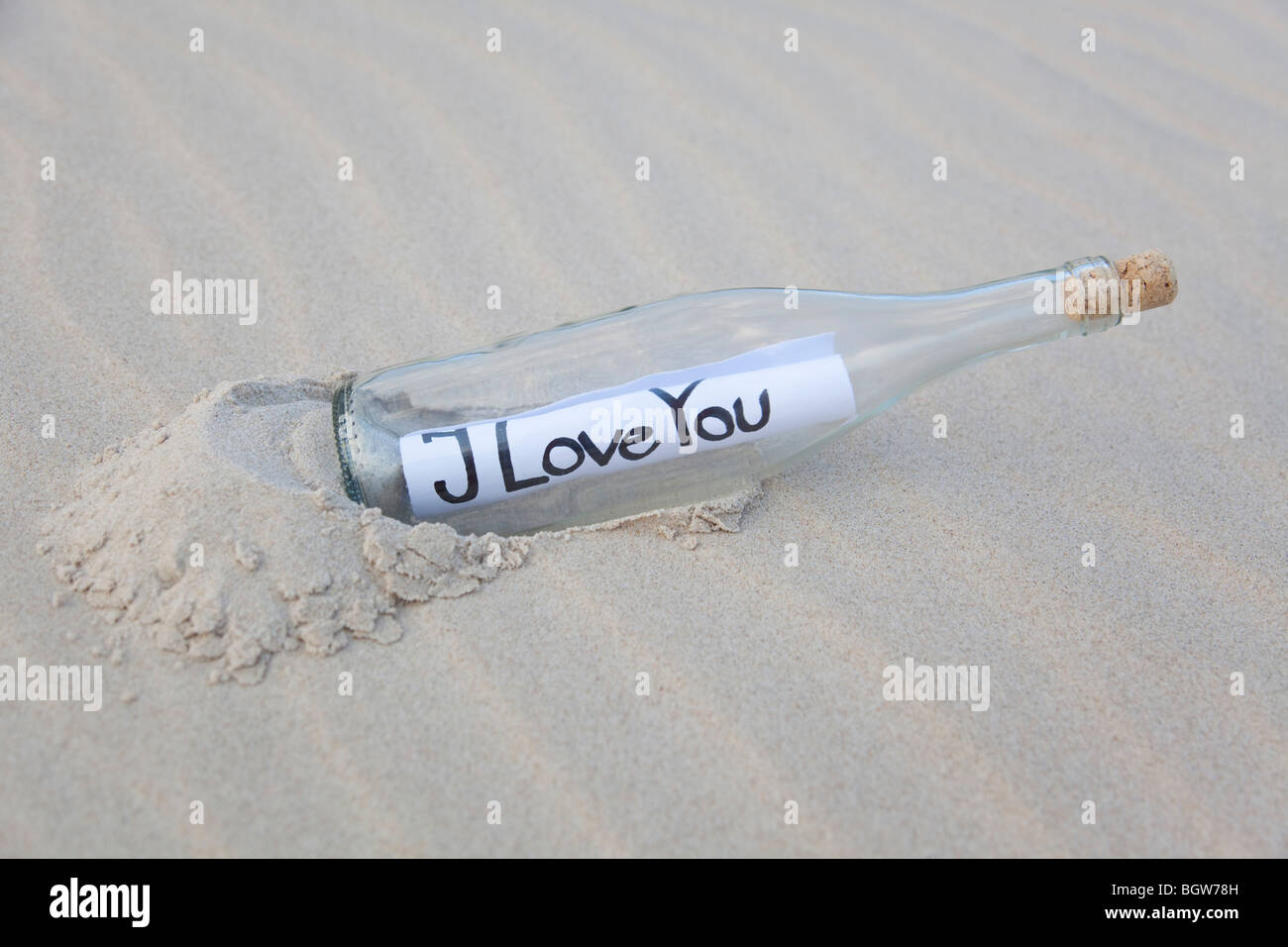 A clear glass bottle washed up on the beach Stock Photo - Alamy