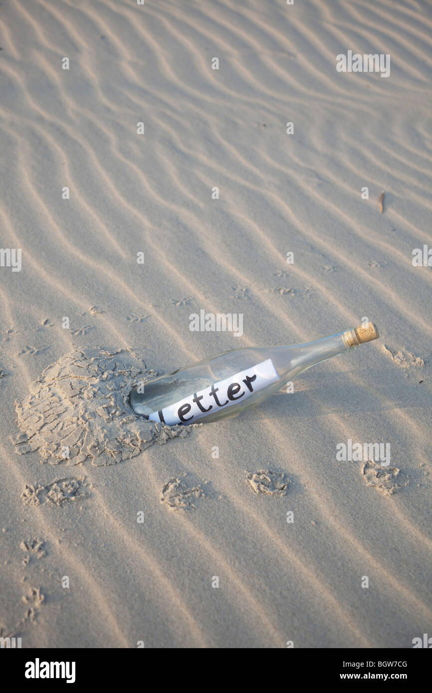 A clear glass bottle washed up on the beach Stock Photo - Alamy