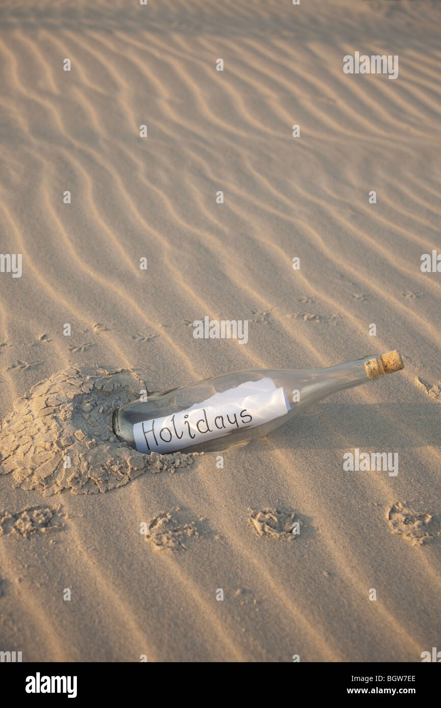 A clear glass bottle washed up on the beach Stock Photo - Alamy