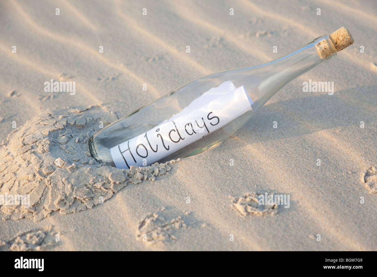 A clear glass bottle washed up on the beach Stock Photo - Alamy