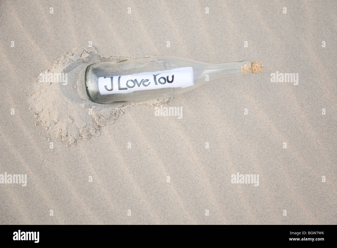 A clear glass bottle washed up on the beach Stock Photo - Alamy