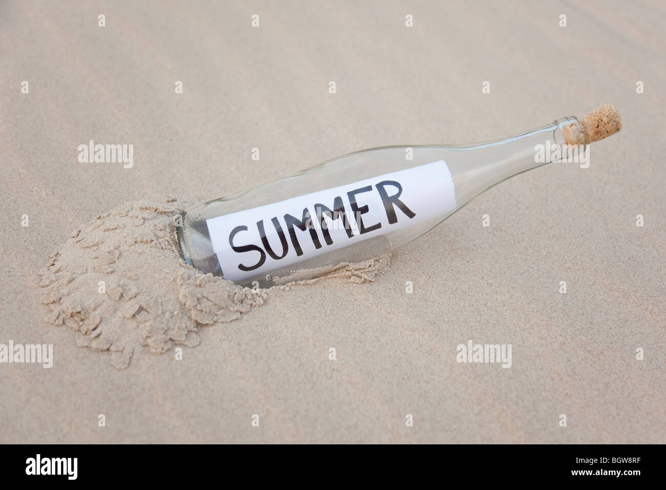 A clear glass bottle washed up on the beach Stock Photo - Alamy