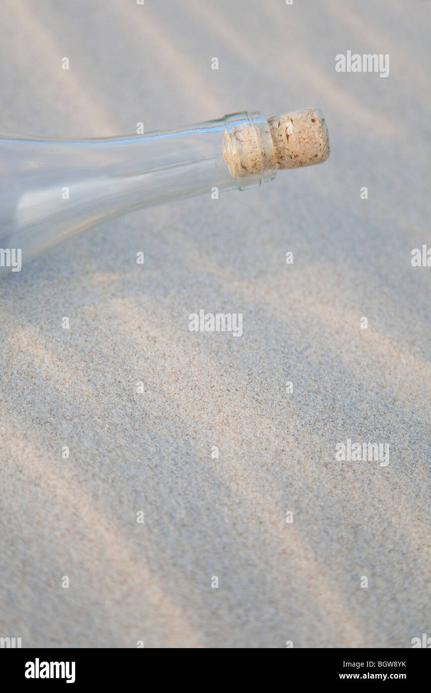 A clear glass bottle washed up on the beach Stock Photo - Alamy