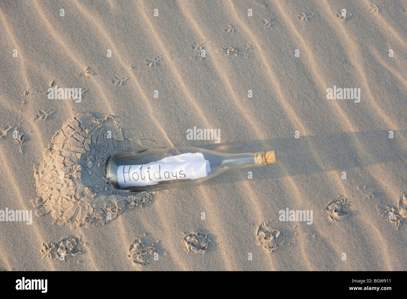 A clear glass bottle washed up on the beach Stock Photo - Alamy