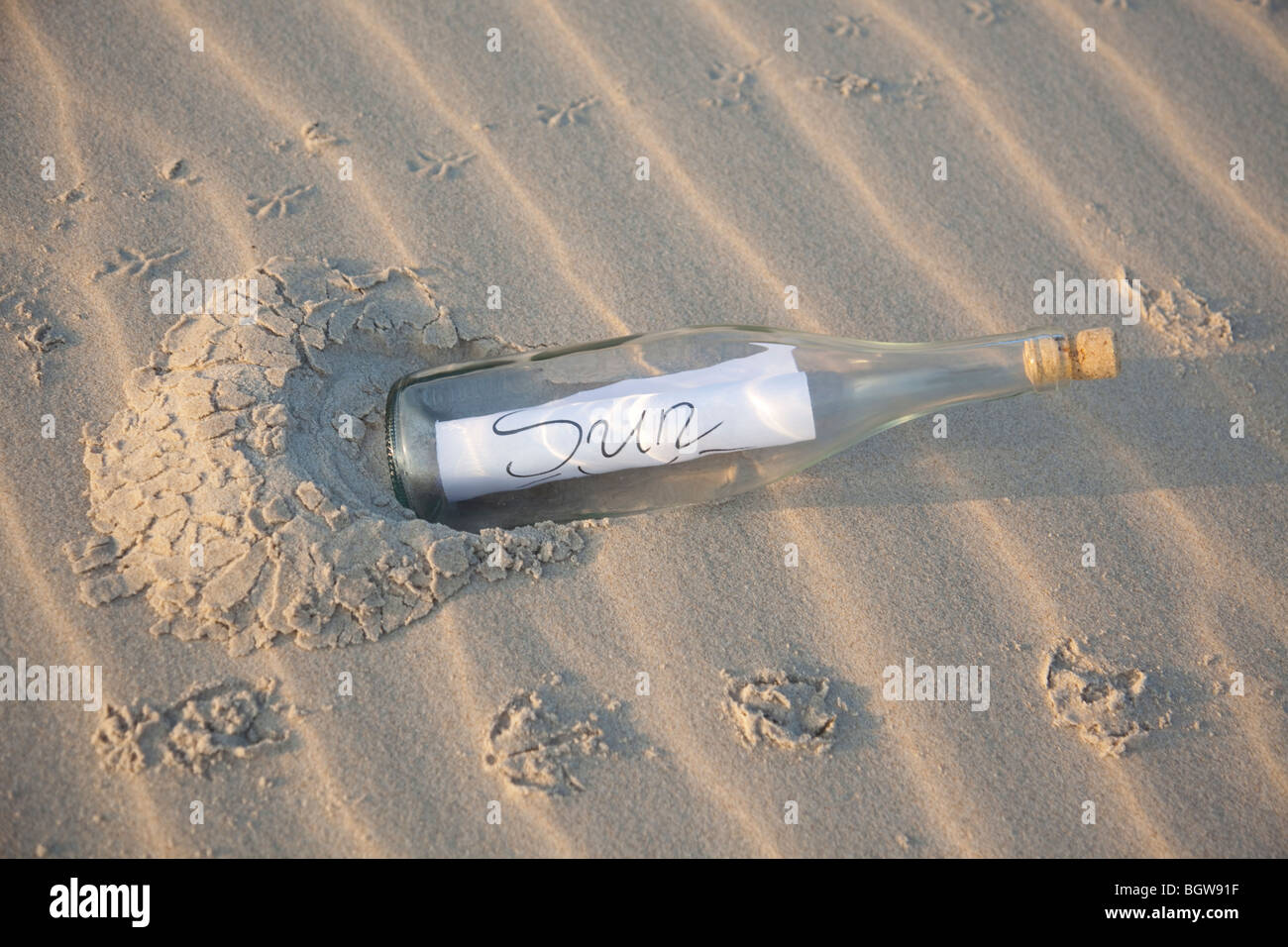 A clear glass bottle washed up on the beach Stock Photo - Alamy