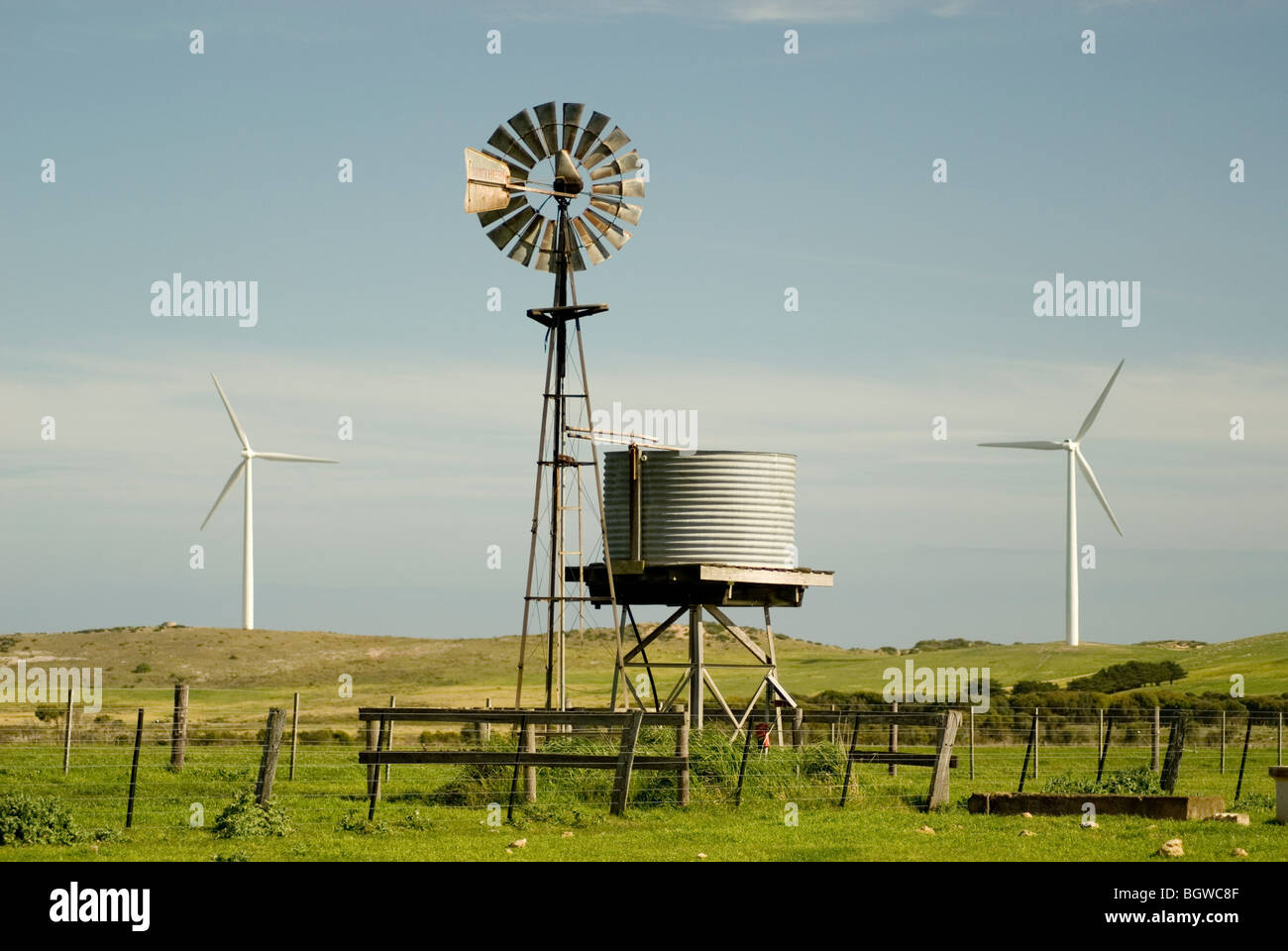 Traditional windmill contrasts with wind turbines at Codrington Wind ...