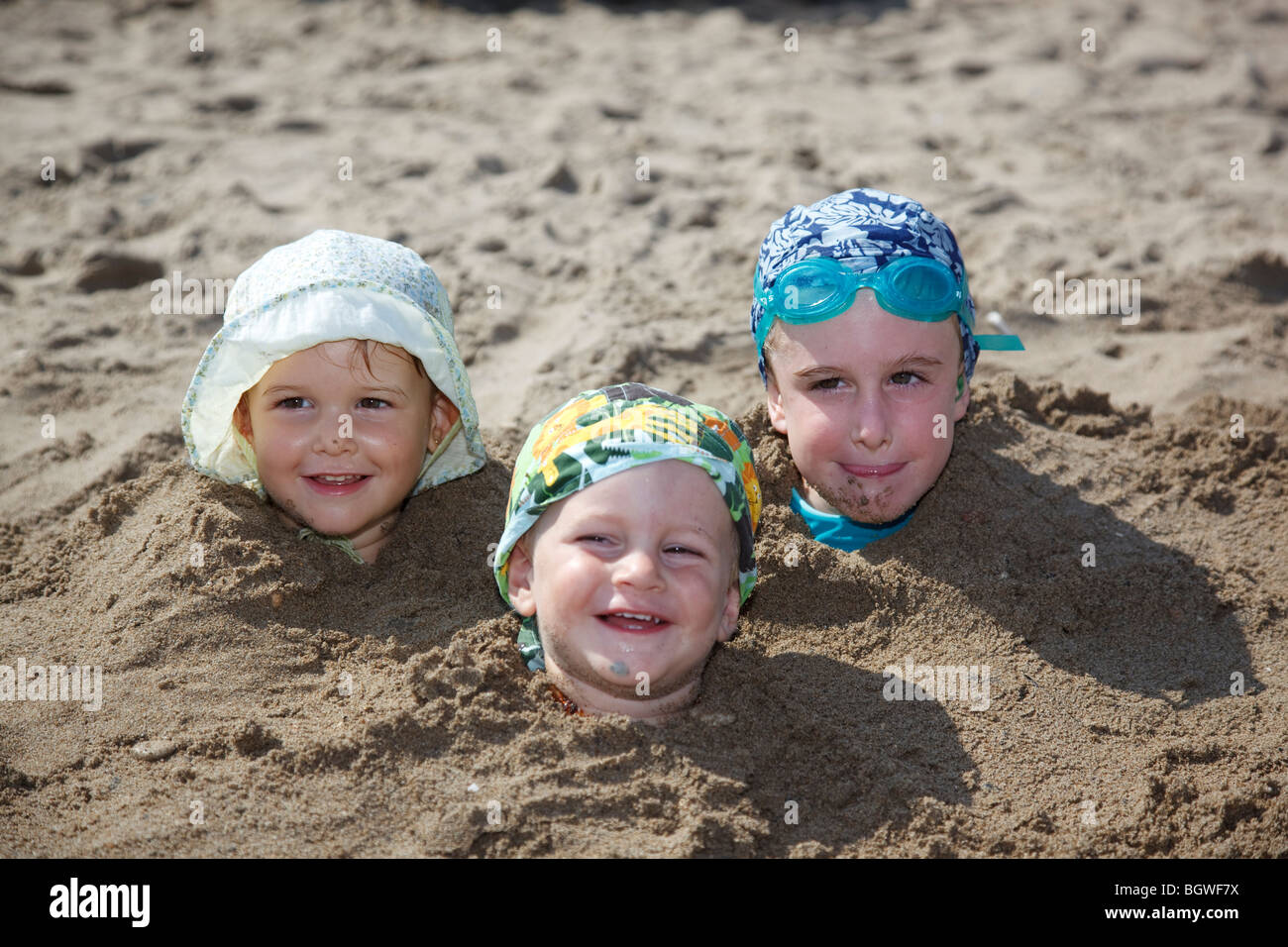 children dug in sand Stock Photo - Alamy