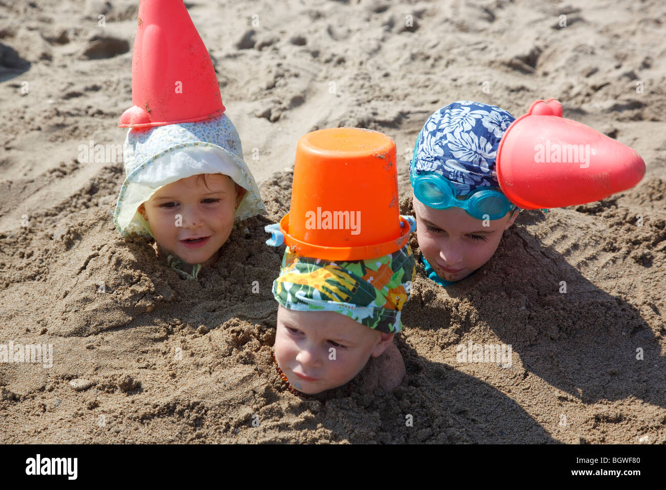 children dug in sand Stock Photo - Alamy
