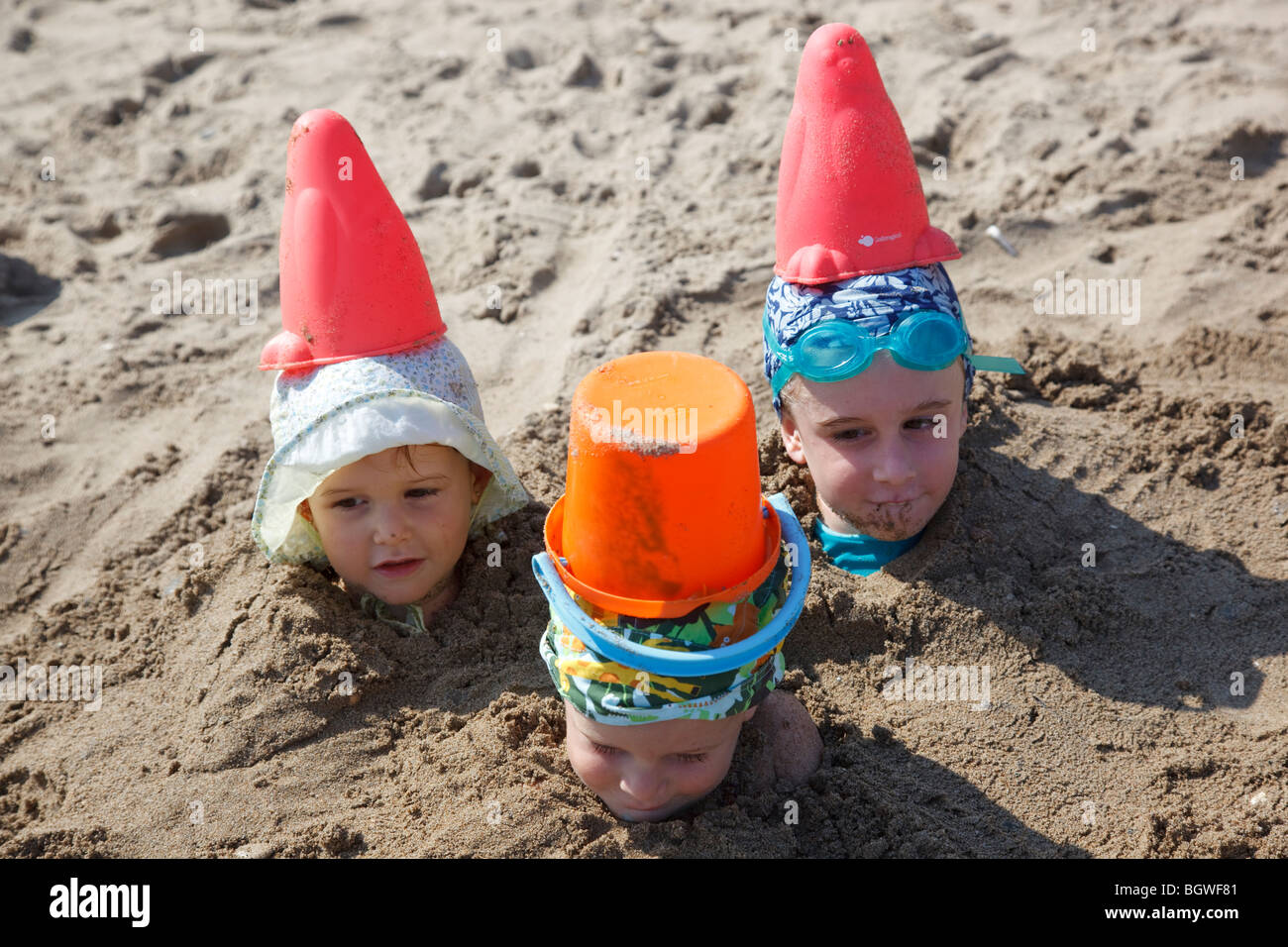 children dug in sand Stock Photo - Alamy