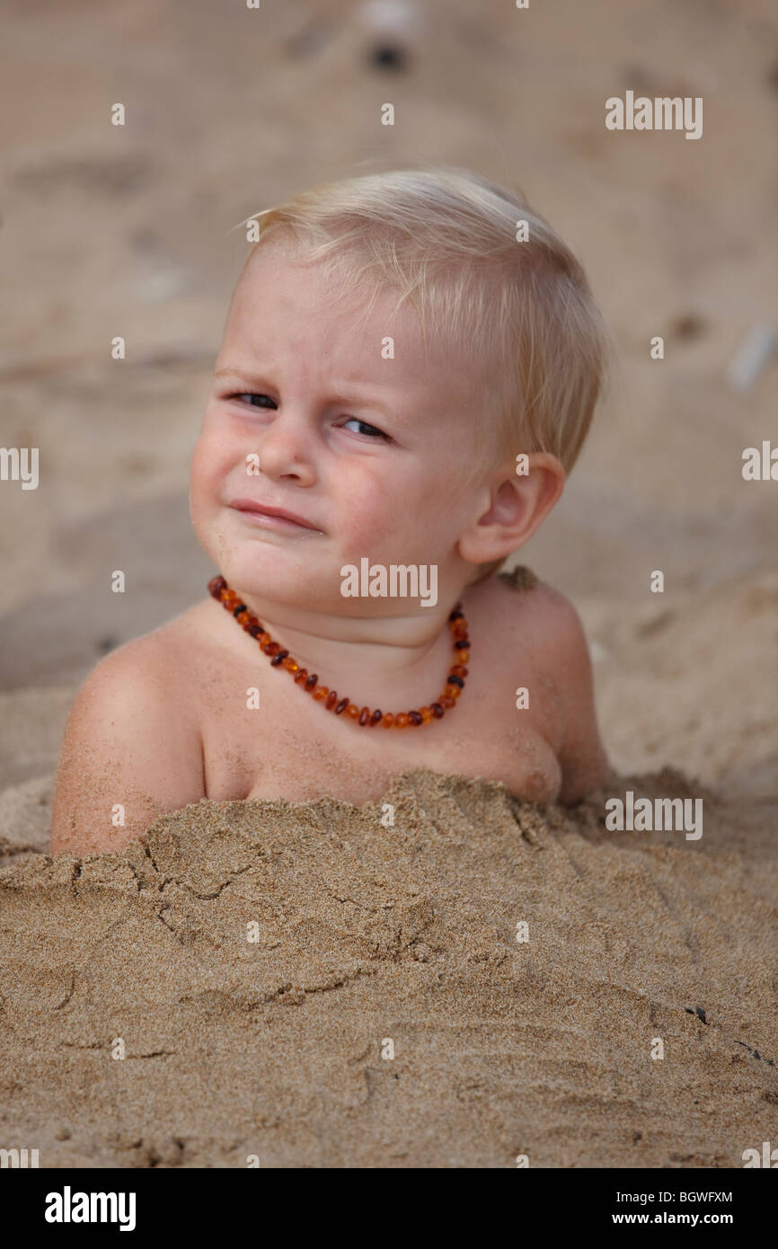little boy dug into sand Stock Photo - Alamy