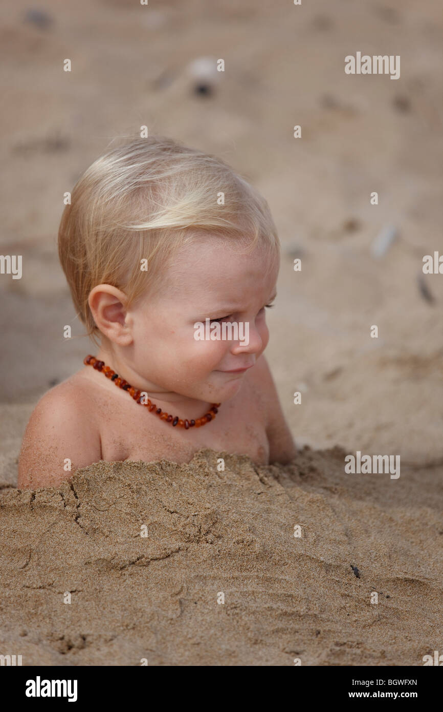 little boy dug into sand Stock Photo - Alamy