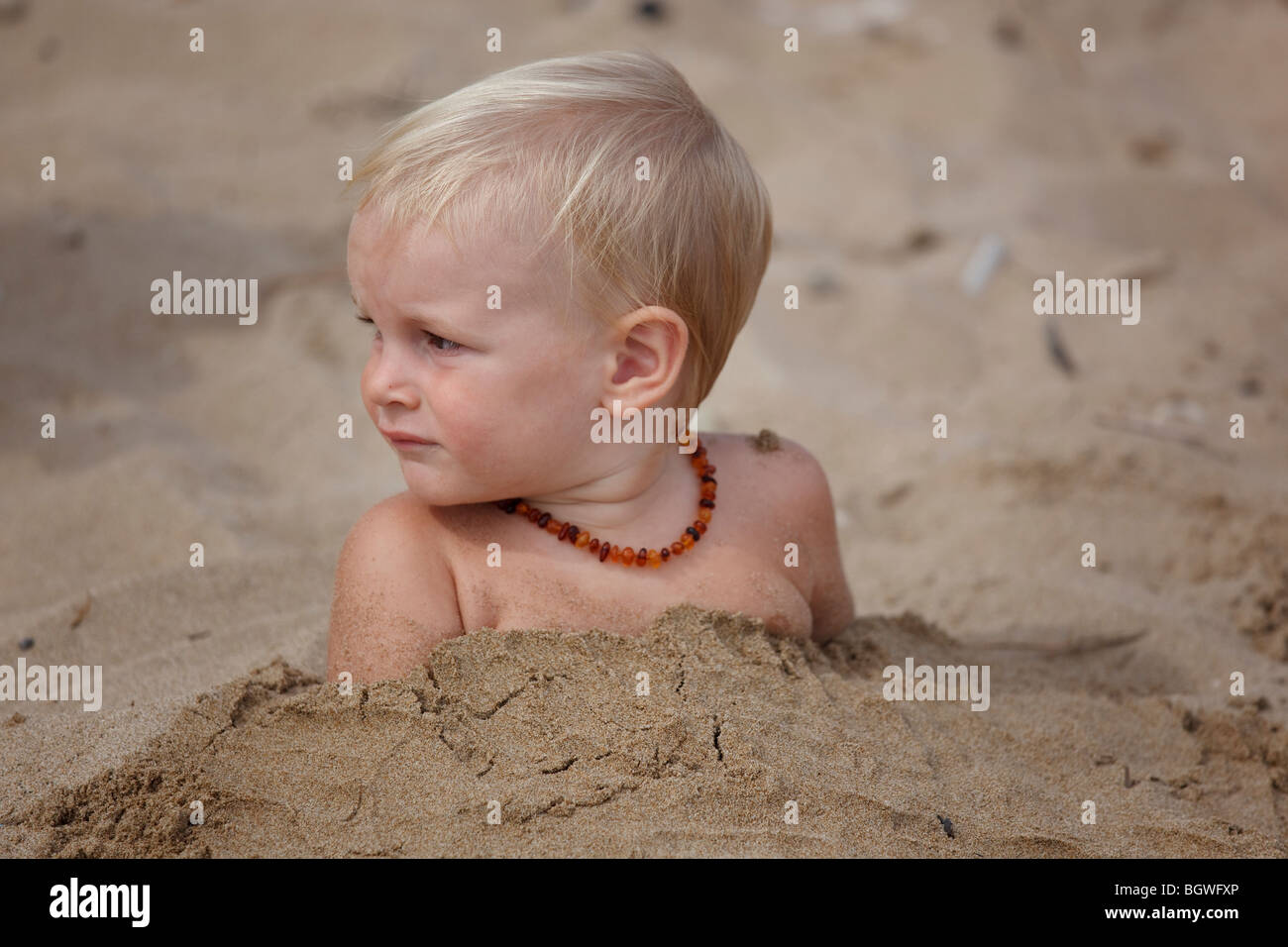 little boy dug into sand Stock Photo - Alamy