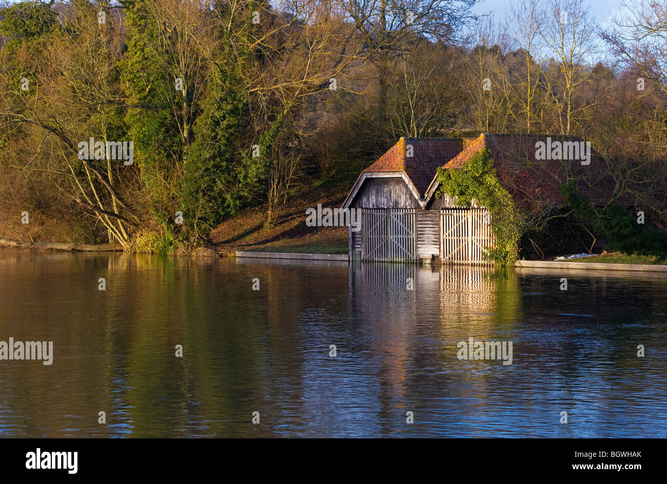 a pair of traditional riverside wooden boat houses on the Thames ...