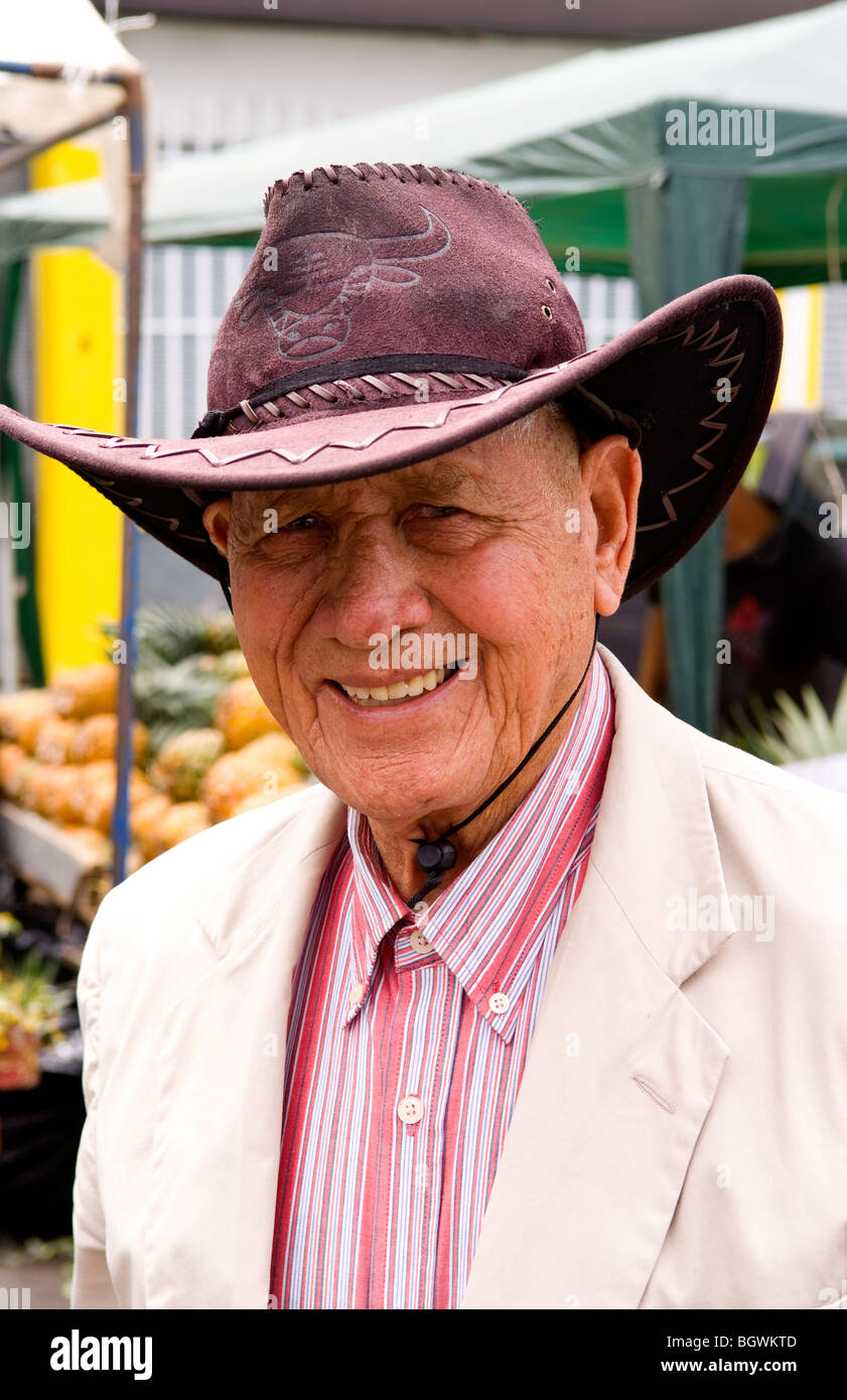 Portrait of smiling local man in Central Market with fruits and ...