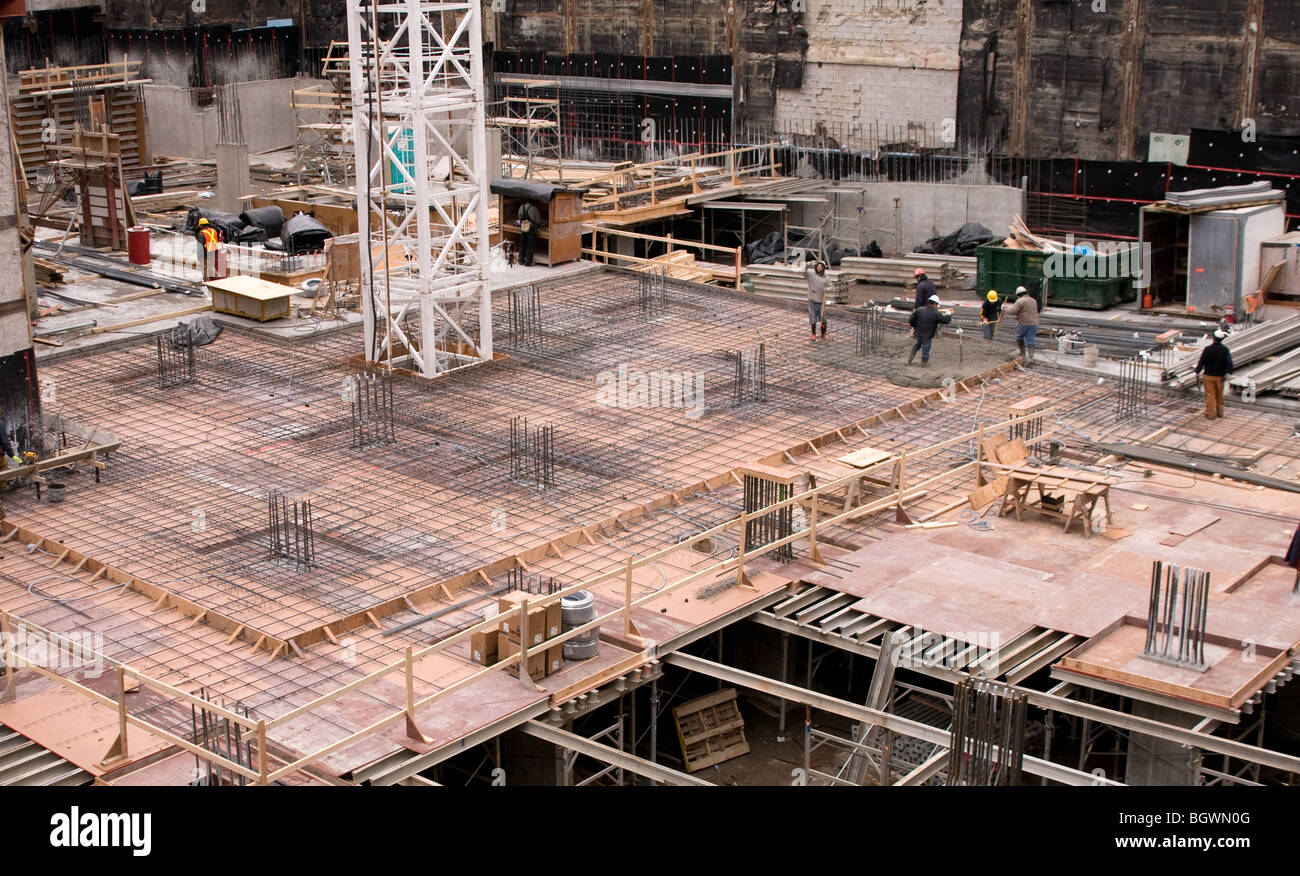 Site square with climbing crane and construction workers Stock Photo ...