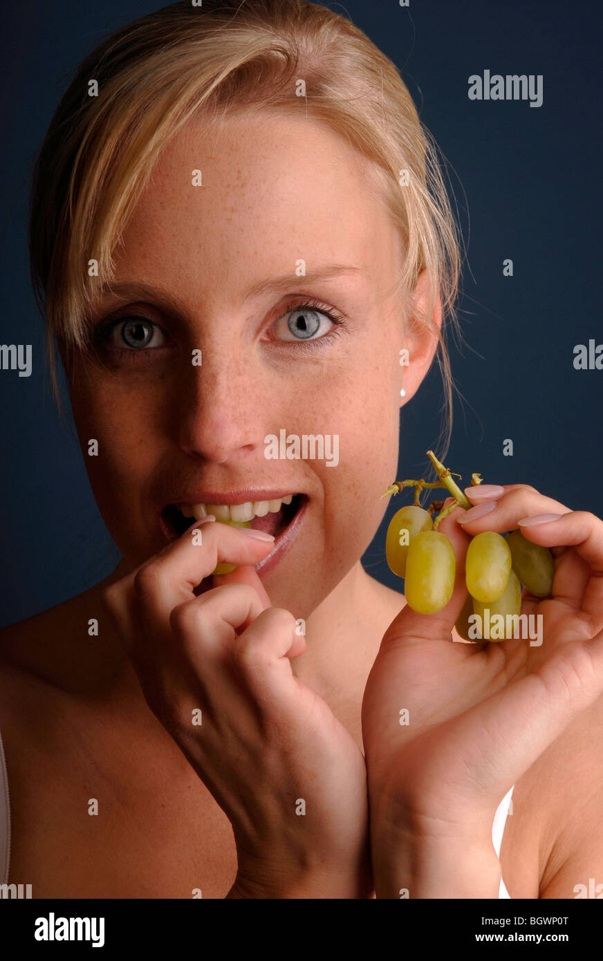 Young women eat grapes hi-res stock photography and images - Alamy