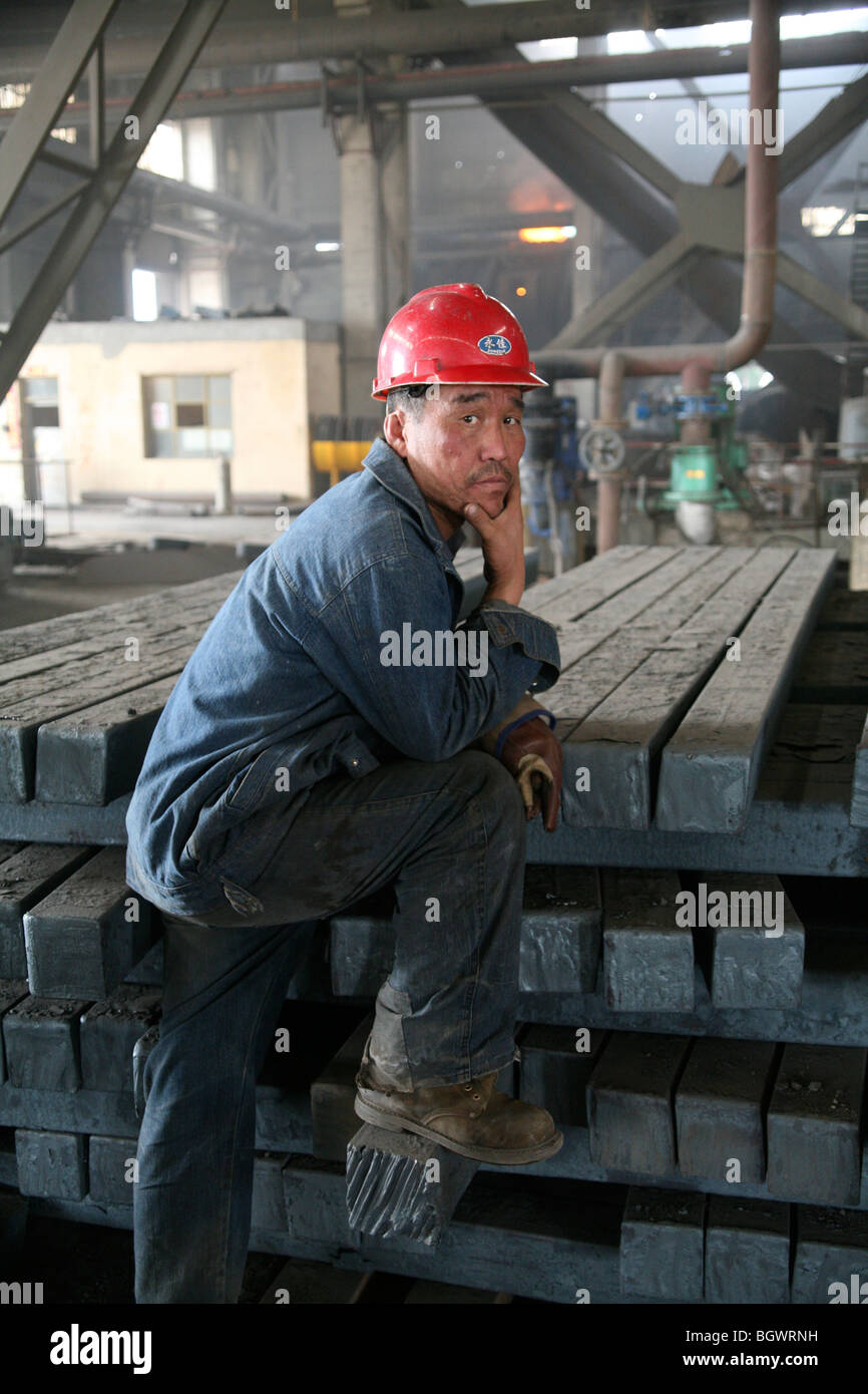 Thoughtful Chinese steel worker resting Stock Photo - Alamy