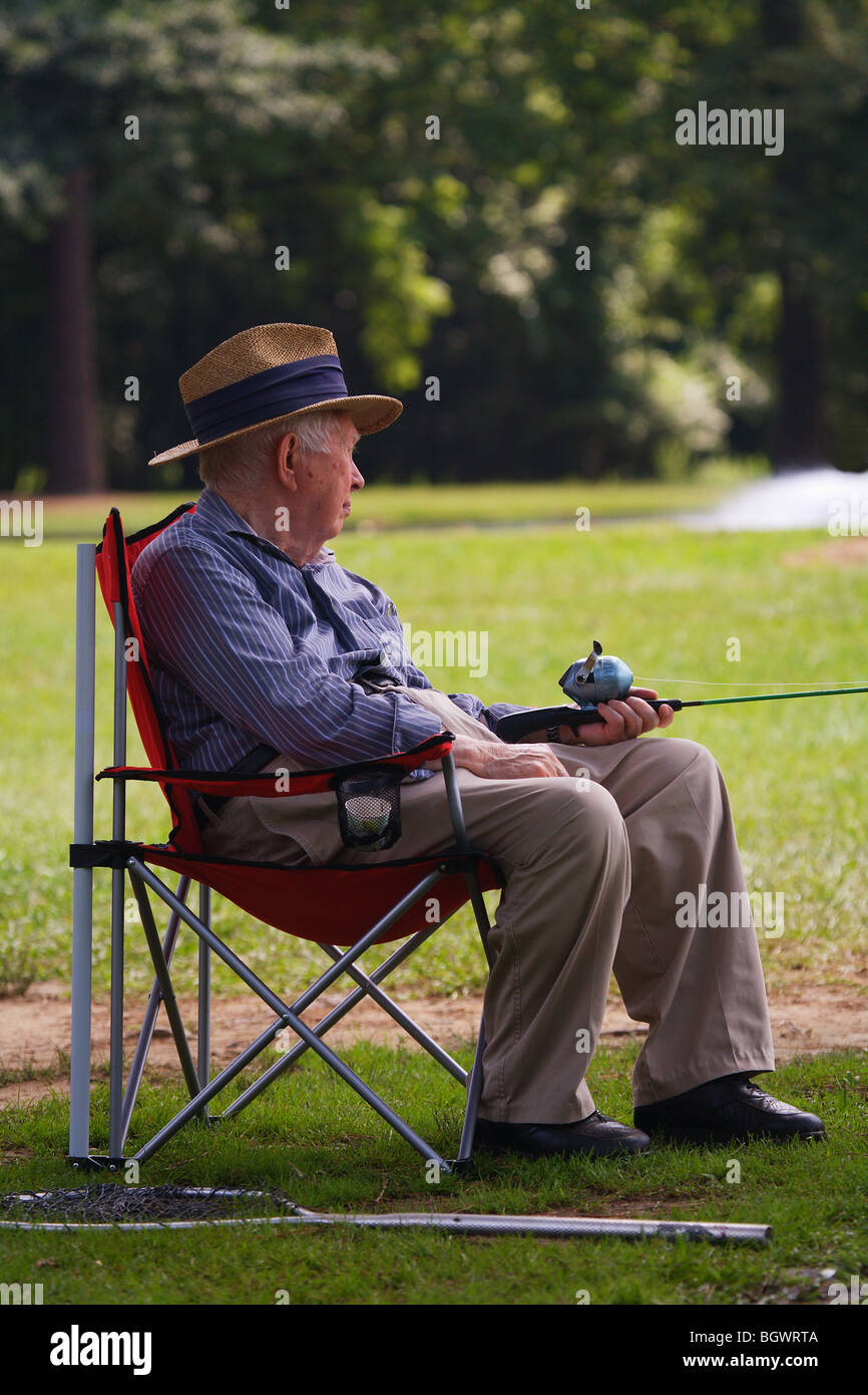 Man sitting in chair fishing hi-res stock photography and images - Alamy