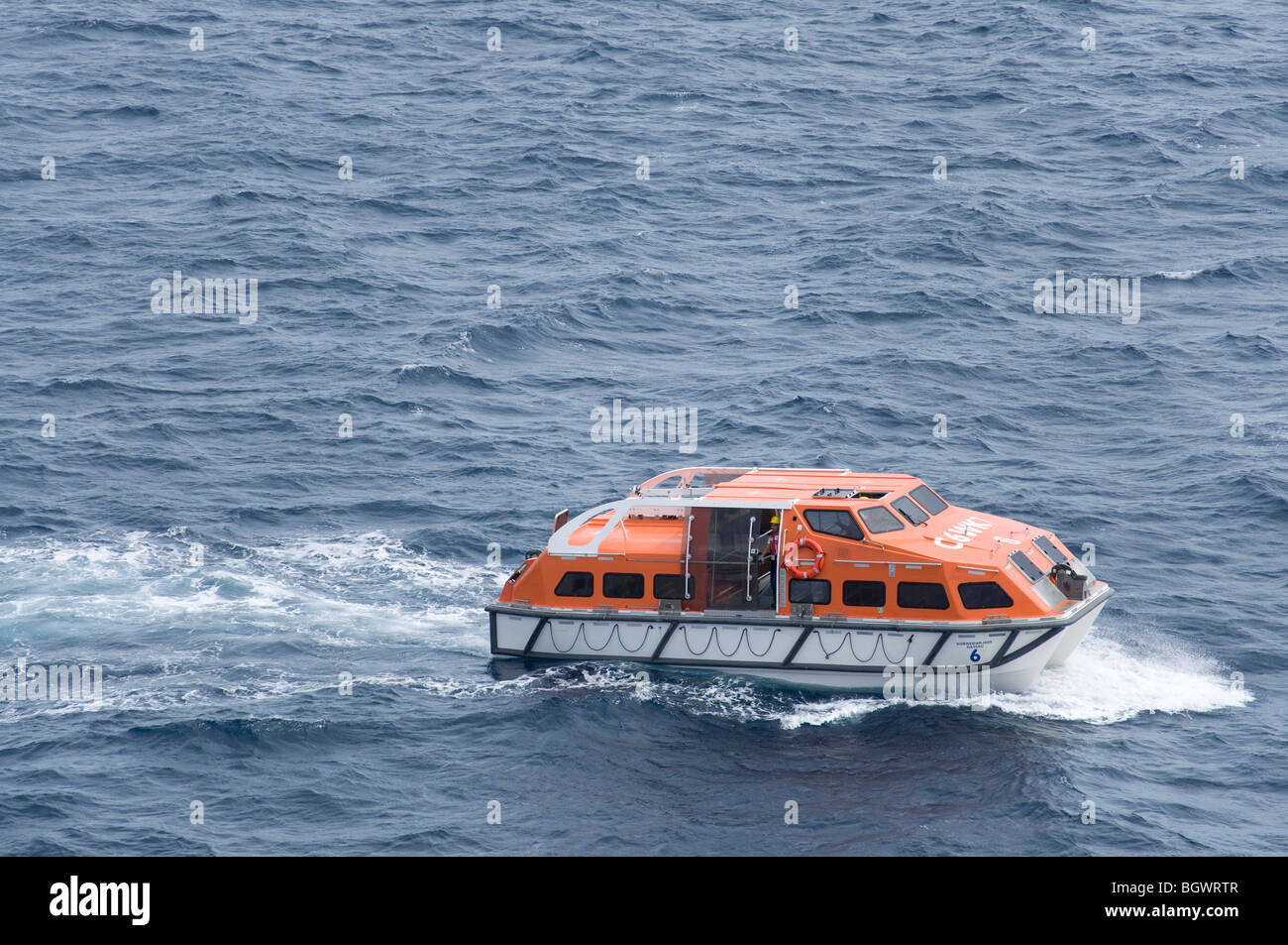 An NCL tender boat carrying passengers from shore to cruise ship in ...