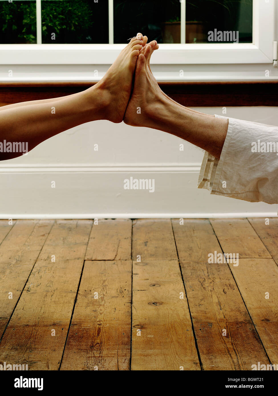 Stretching Legs In Yoga Poses Stock Photo Alamy