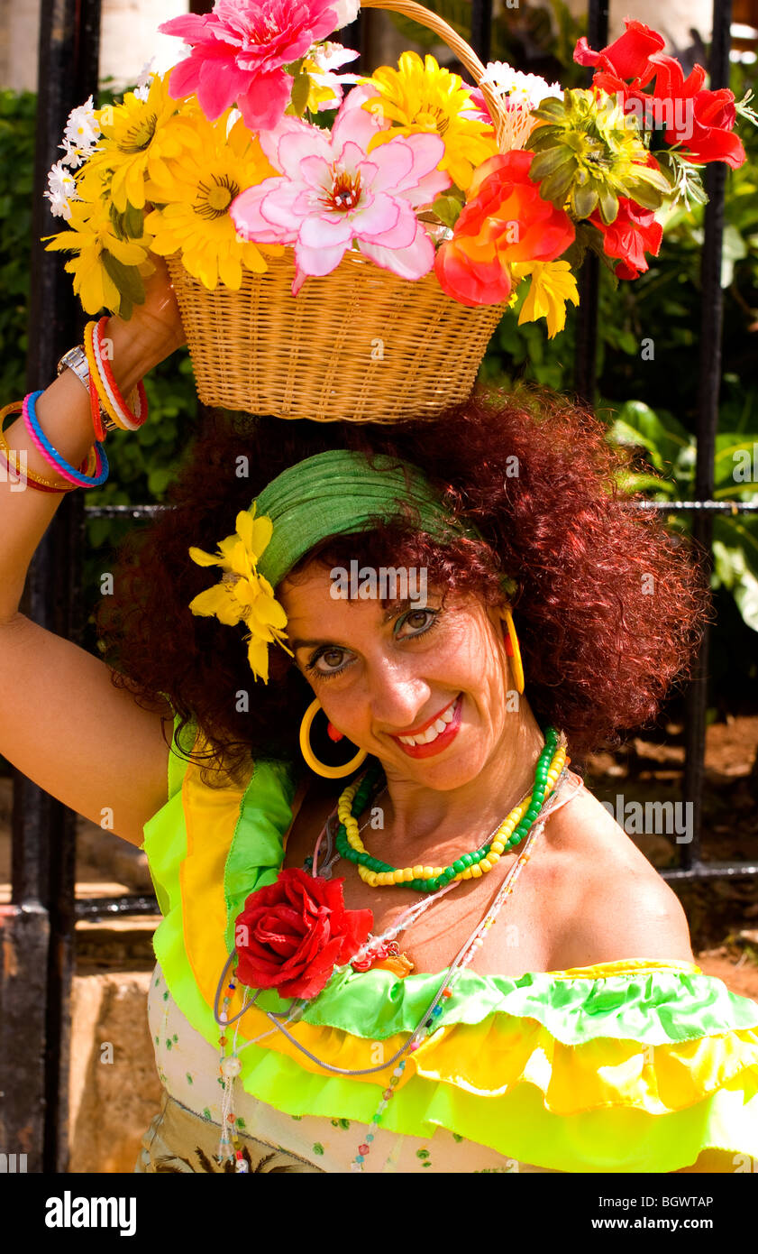 Portrait of smiling woman with flower basket in downtown Havana Cuba ...