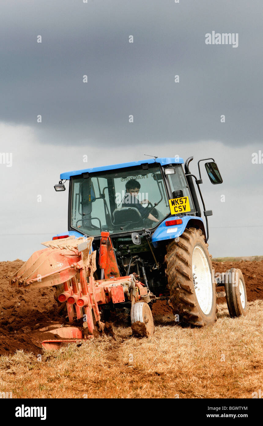 Tractor in a field Stock Photo - Alamy