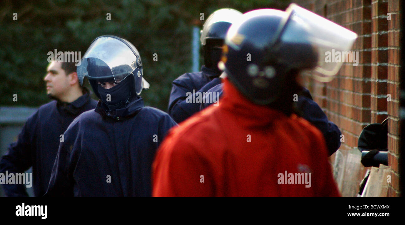 Riot police getting ready for action Stock Photo - Alamy
