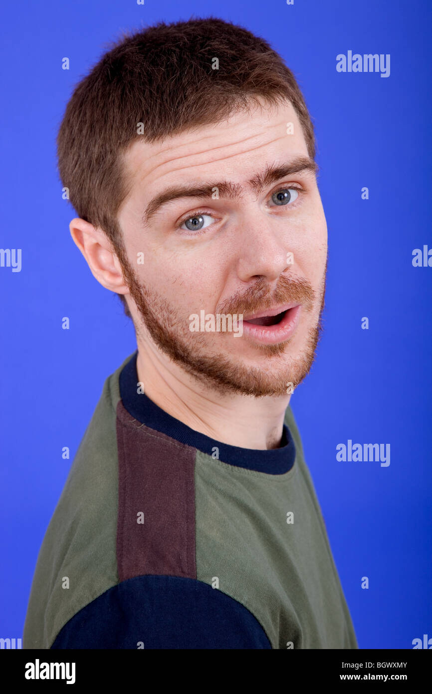 an young man portrait over a blue background Stock Photo - Alamy
